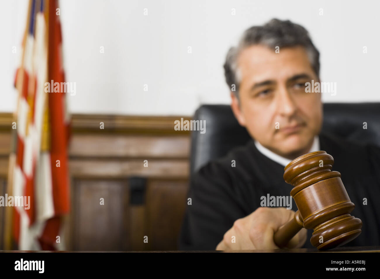 A male judge hitting a gavel on the bench Stock Photo - Alamy