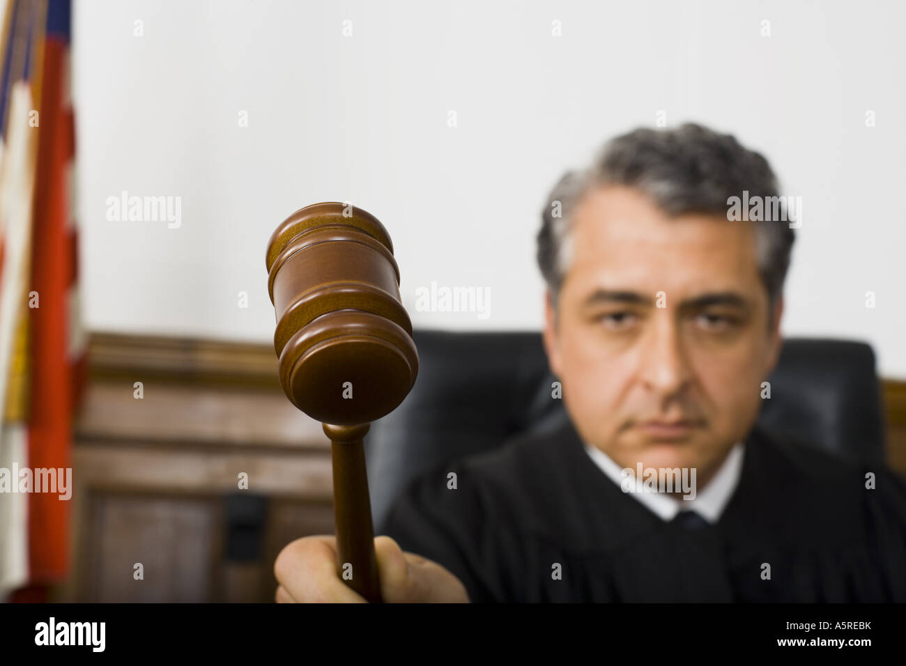 A male judge hitting a gavel on the bench Stock Photo - Alamy