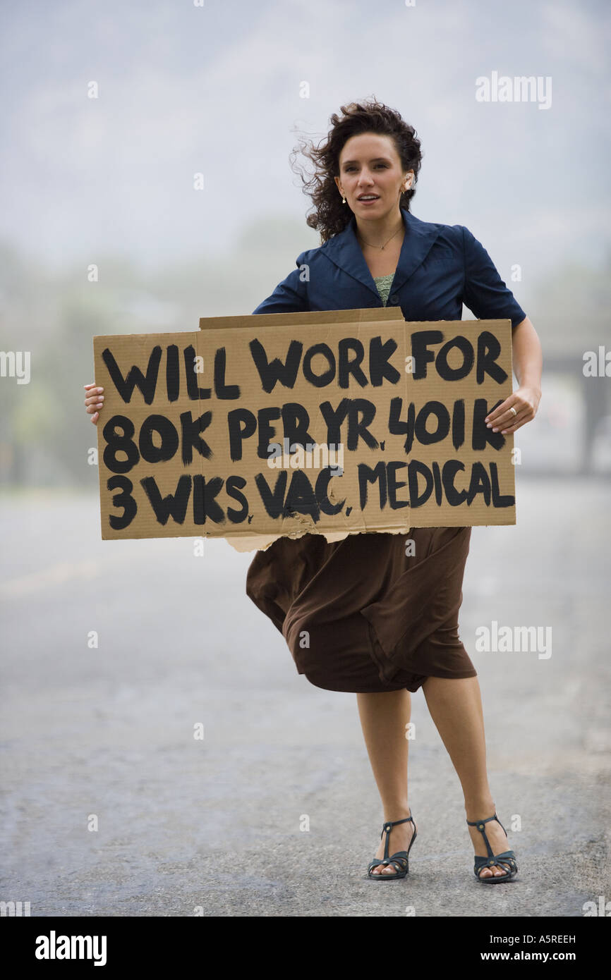Young woman holding a work wanted sign Stock Photo - Alamy
