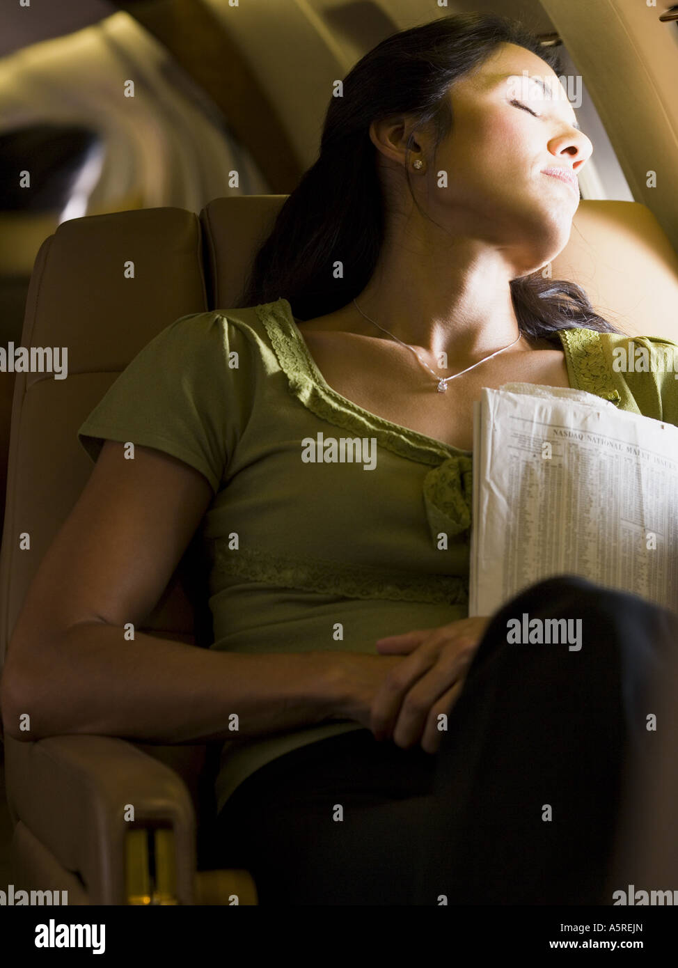 A businesswoman sleeping in an airplane Stock Photo - Alamy