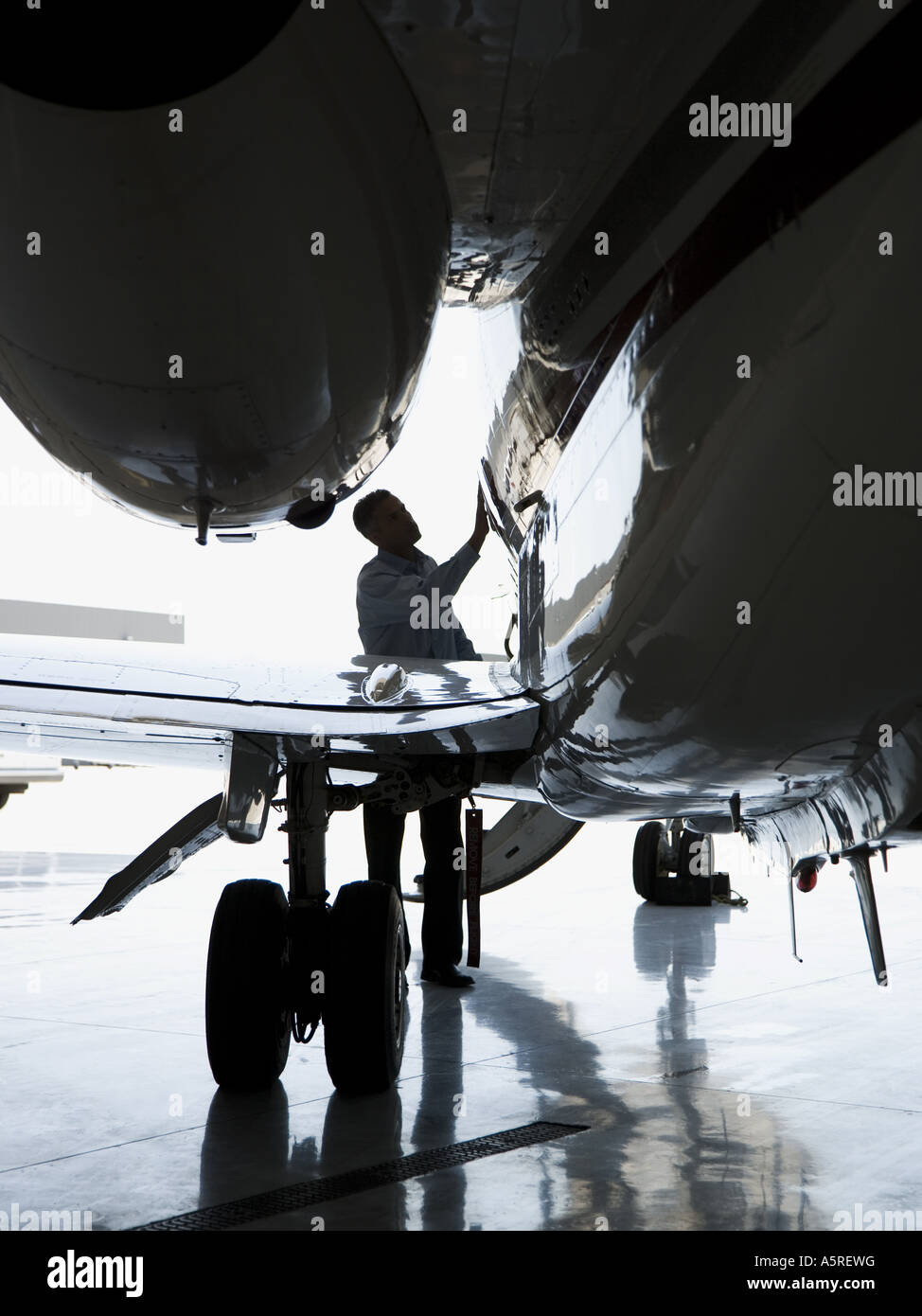 A man inspecting an airplane Stock Photo - Alamy