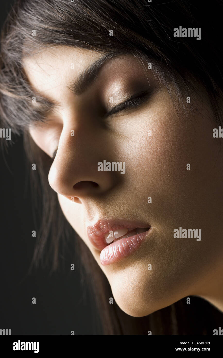 Close up of a young woman with her eyes closed Stock Photo - Alamy
