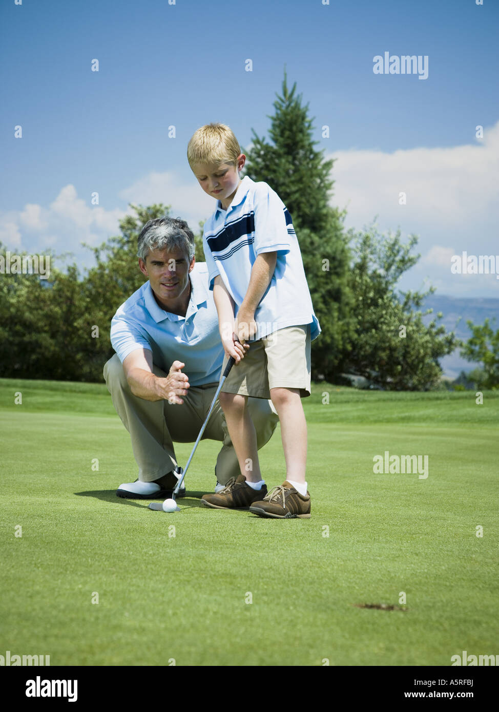Father teaching son golf hi-res stock photography and images - Alamy