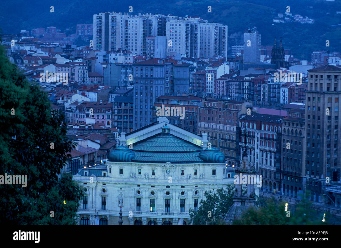 THE BILBAO OPERA HOUSE STANDS IN FRONT OF OLD DERELICT WAREHOUSES ...