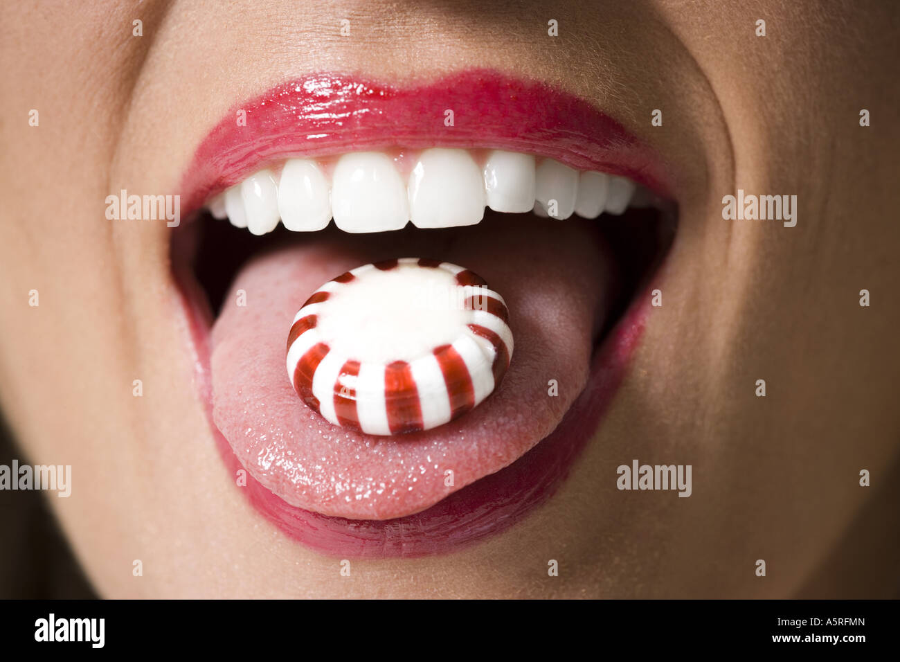 Close up of candy on a young woman s tongue Stock Photo - Alamy