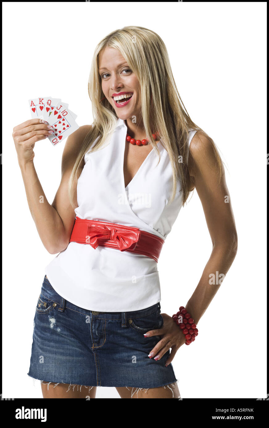 Portrait of a young woman showing playing cards and smiling Stock Photo ...