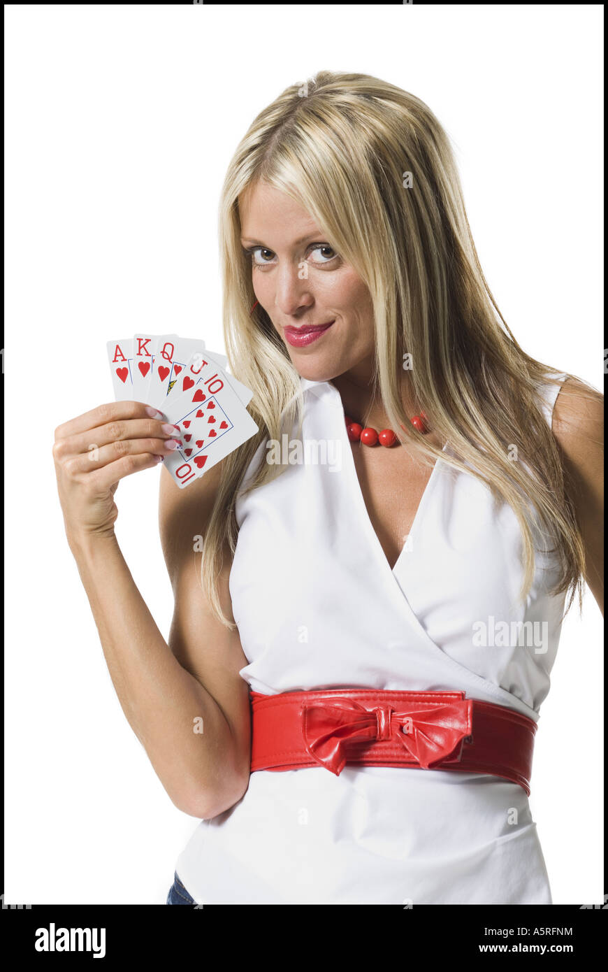Portrait of a young woman showing playing cards and smiling Stock Photo ...