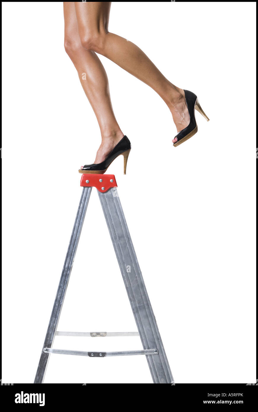 Low section view of a young woman standing on a step ladder Stock Photo ...