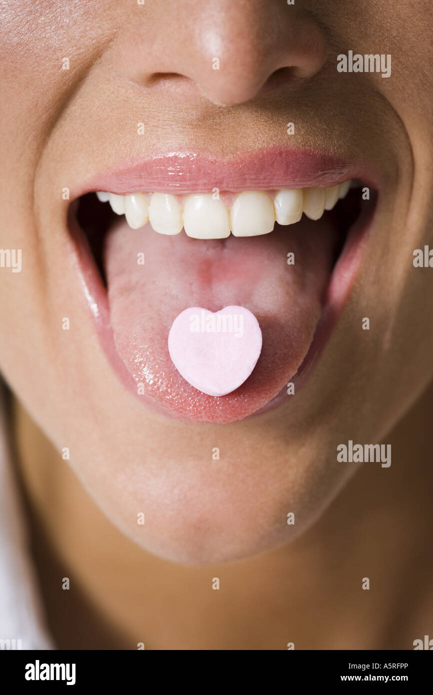 Close up of candy on a young woman s tongue Stock Photo - Alamy