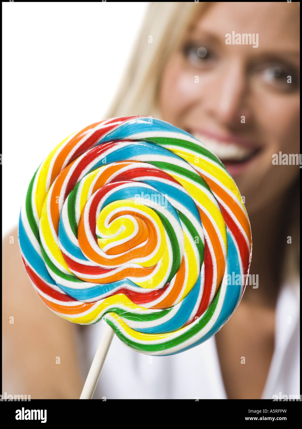 Close up of a young woman holding a lollipop Stock Photo - Alamy