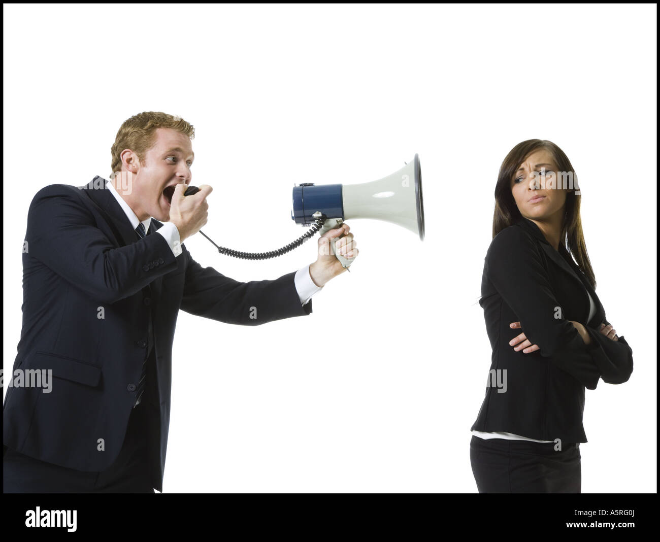 Profile of a businessman shouting into a megaphone with a teenage girl ...