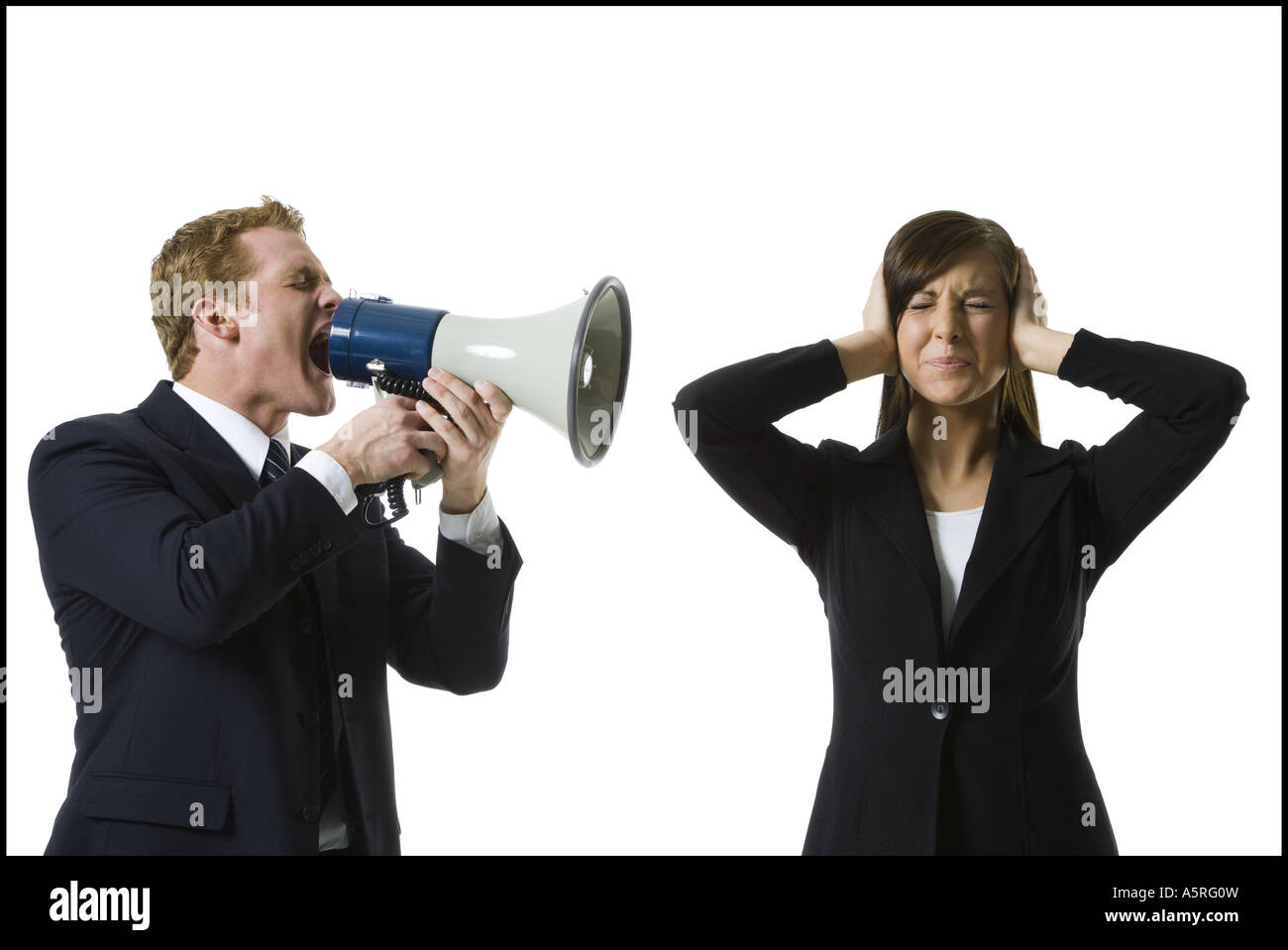 Profile of a businessman shouting into a megaphone with a teenage girl ...