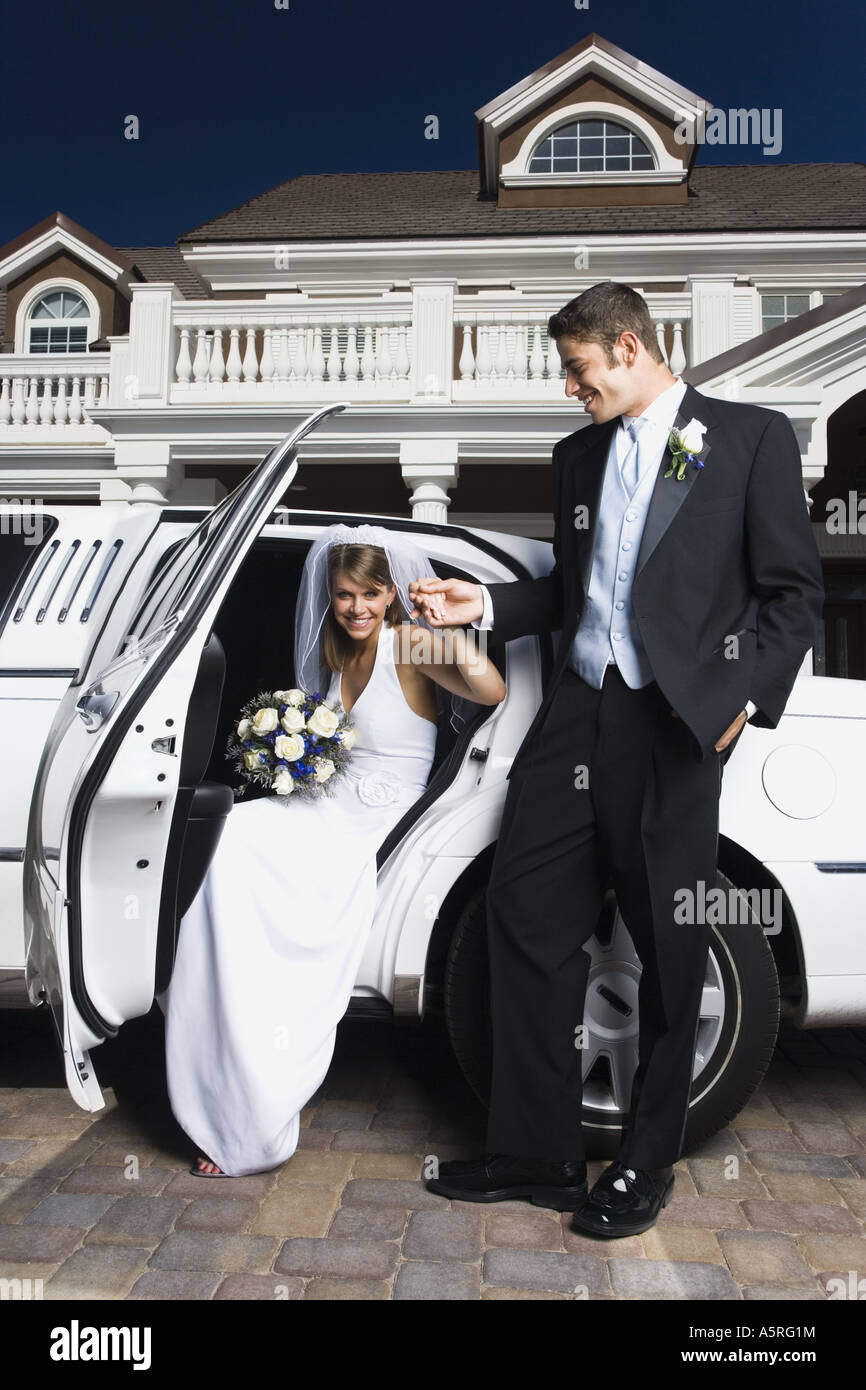 Young man holding his bride s hand and exiting a car Stock Photo - Alamy
