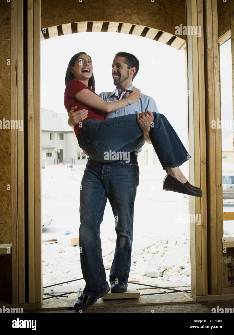 Young man carrying a young woman Stock Photo - Alamy