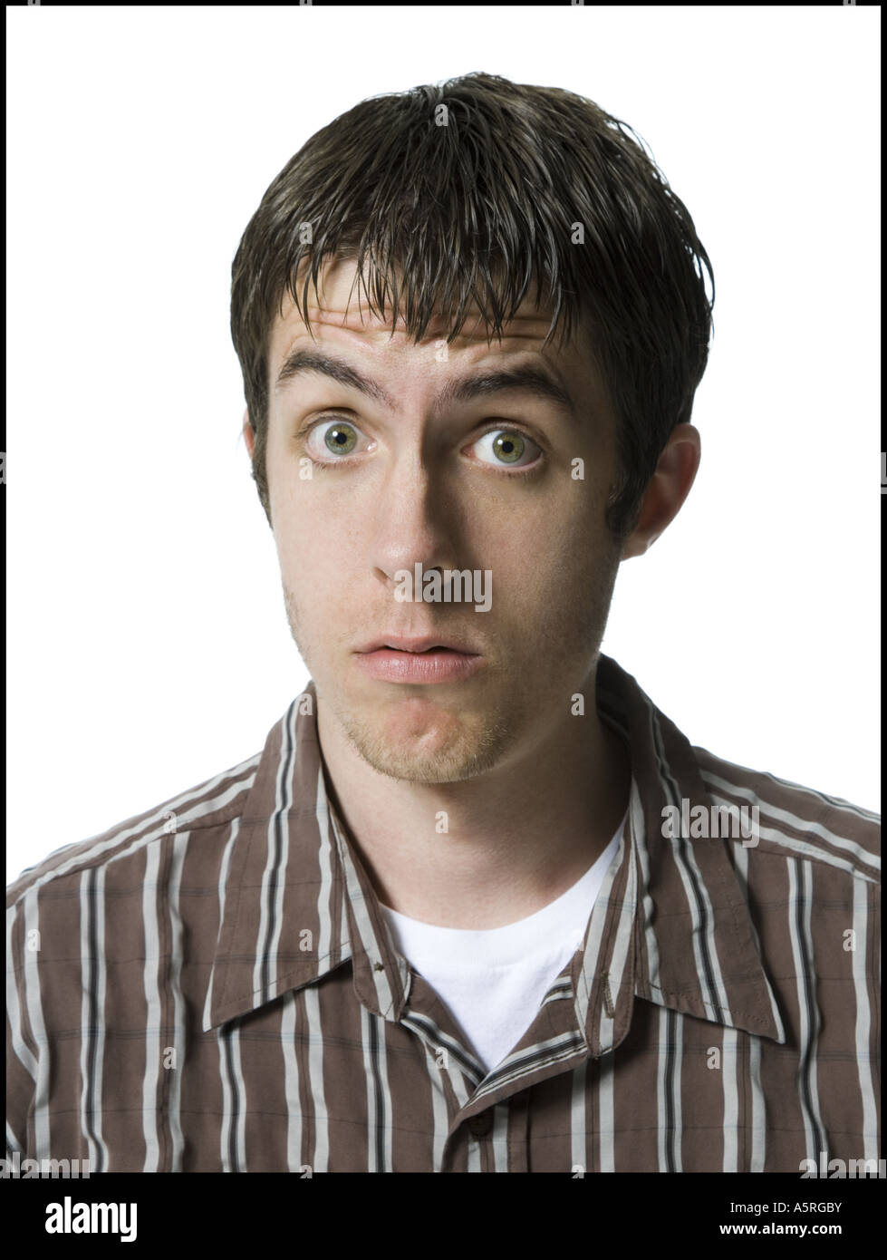 Portrait of a young man looking worried Stock Photo - Alamy