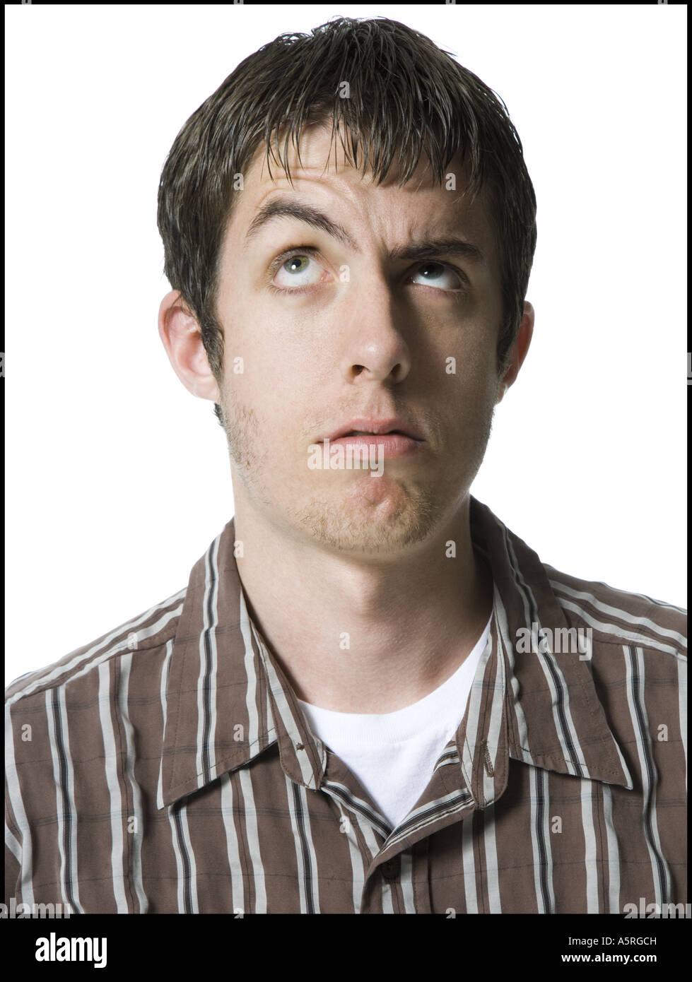 Portrait of a young man looking worried Stock Photo - Alamy