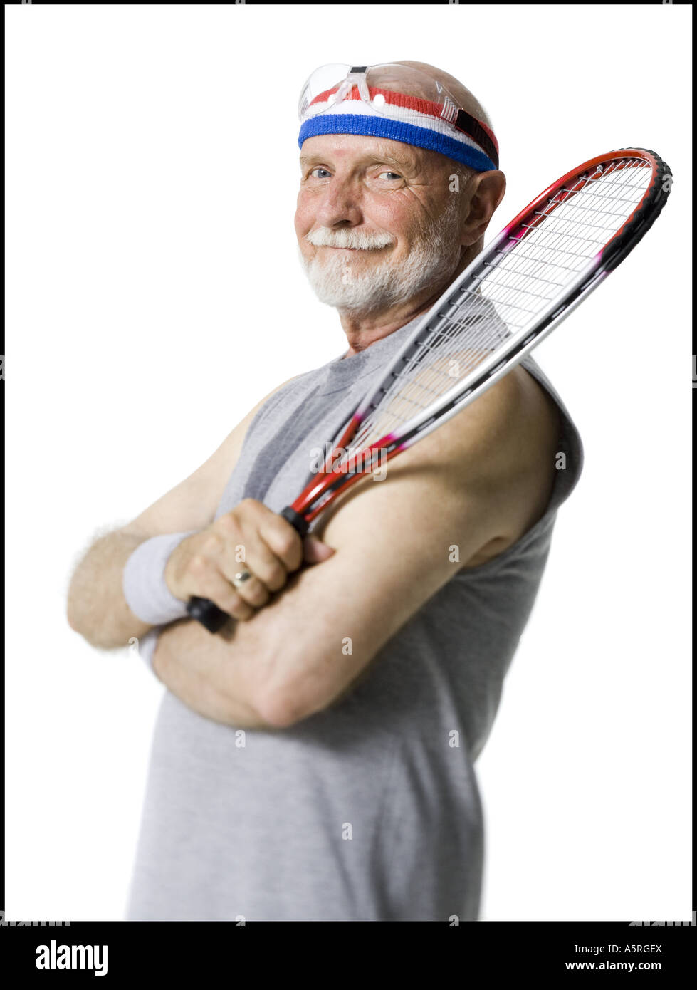 Portrait of a senior man holding a tennis racket Stock Photo - Alamy