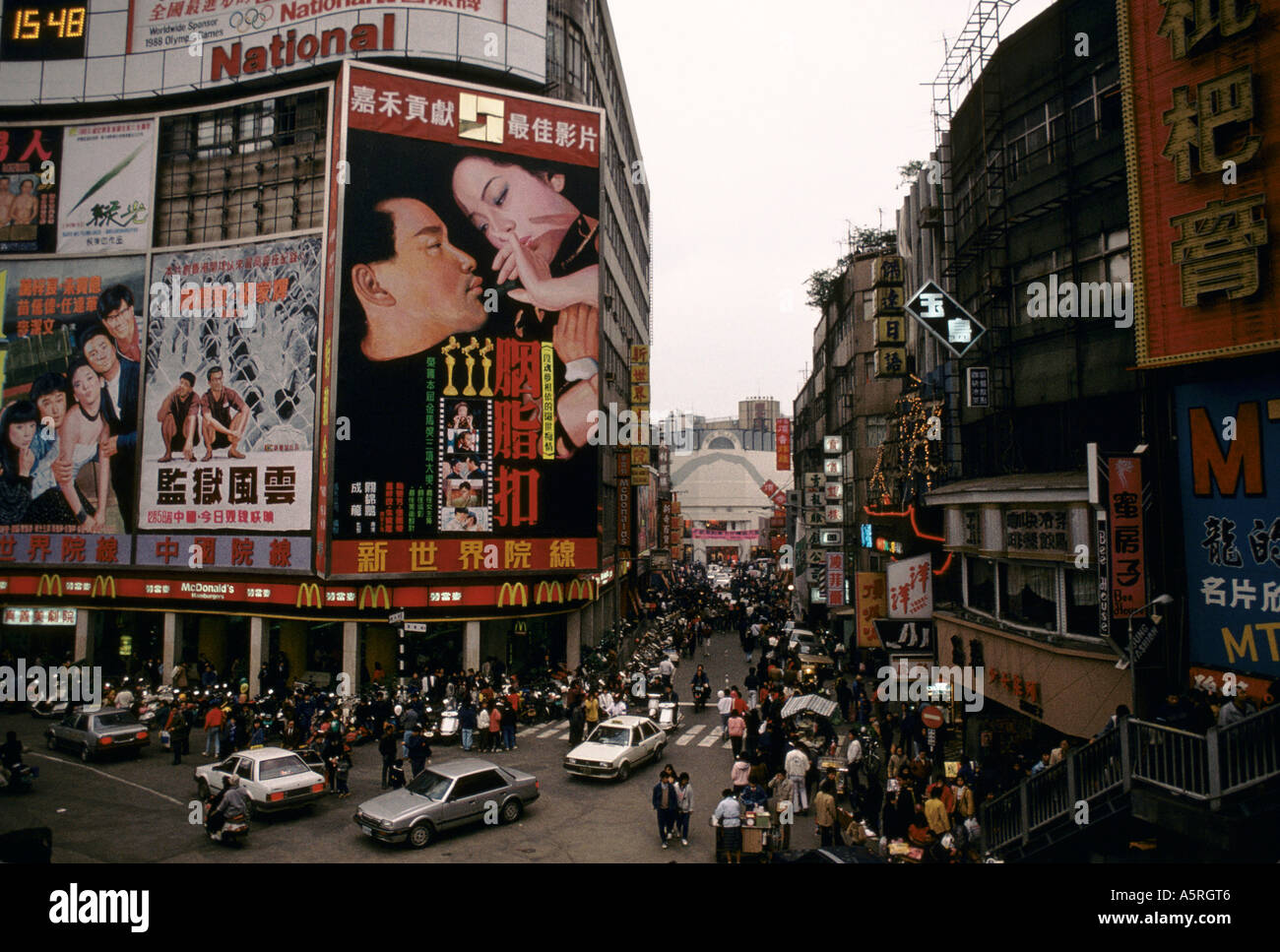 BUSY STREET TRAFFIC PEDESTRIAN SCENE OVERLOOKED BY LARGE SCALE ...