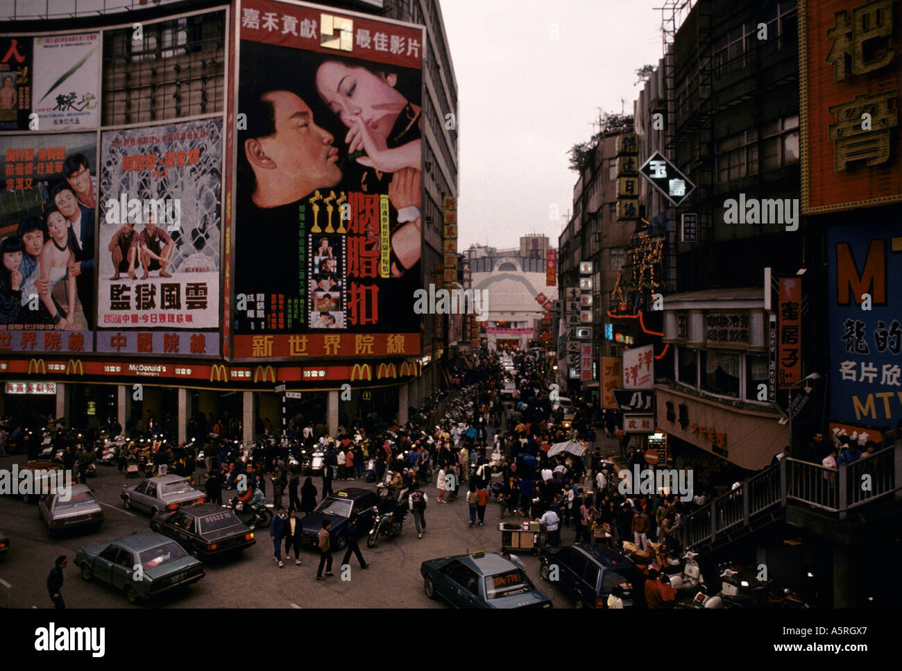 BUSY STREET TRAFFIC PEDESTRIAN SCENE OVERLOOKED BY LARGE SCALE ...