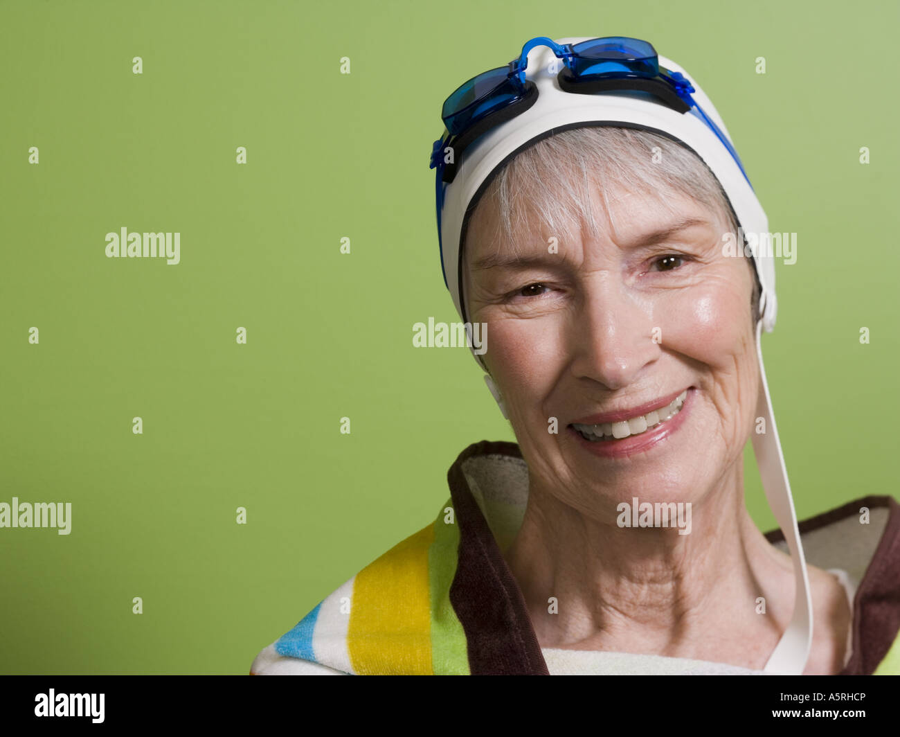 Close up of a senior woman wearing a swimming cap and swimming goggles ...