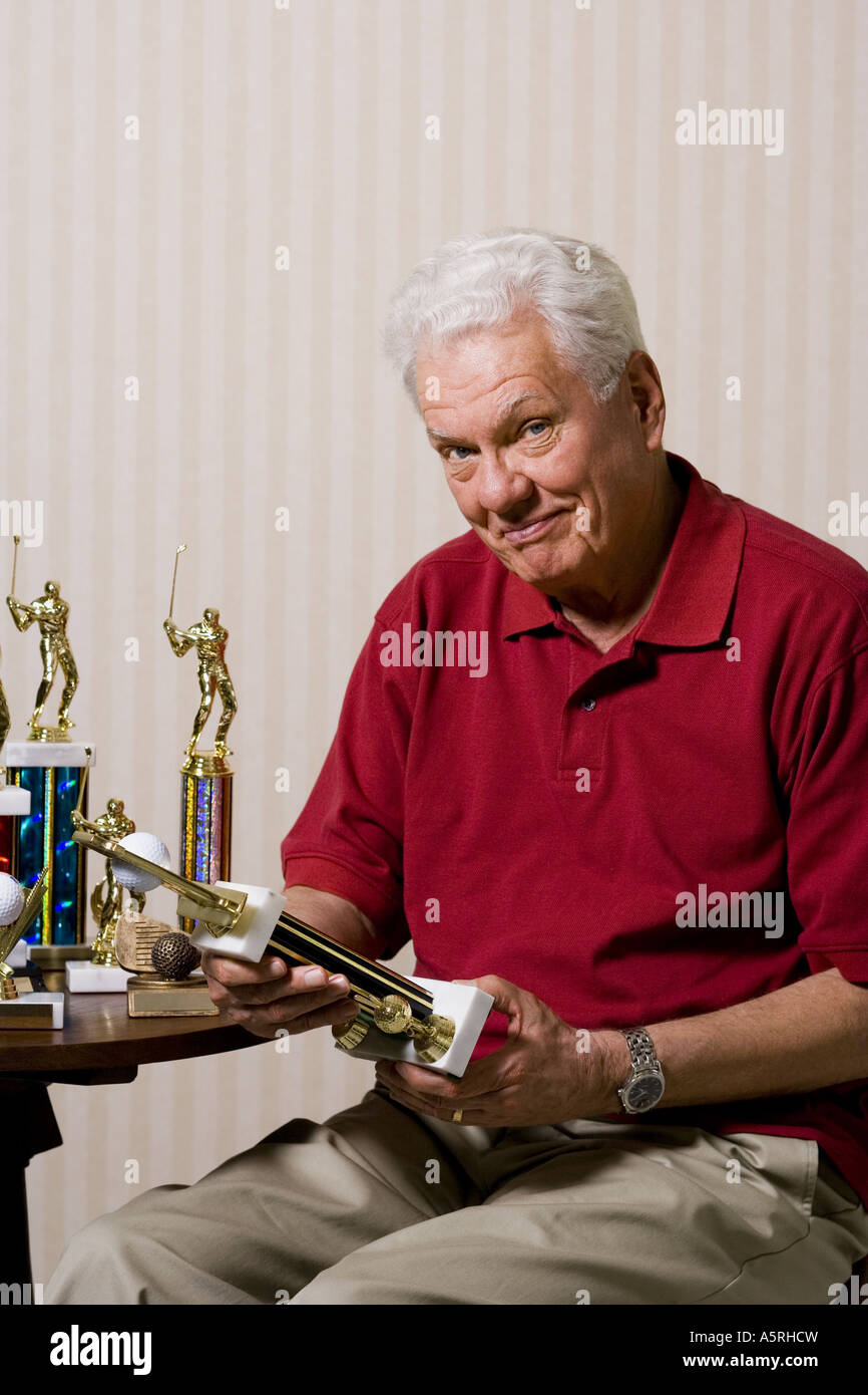 Portrait of a senior man holding a trophy Stock Photo - Alamy