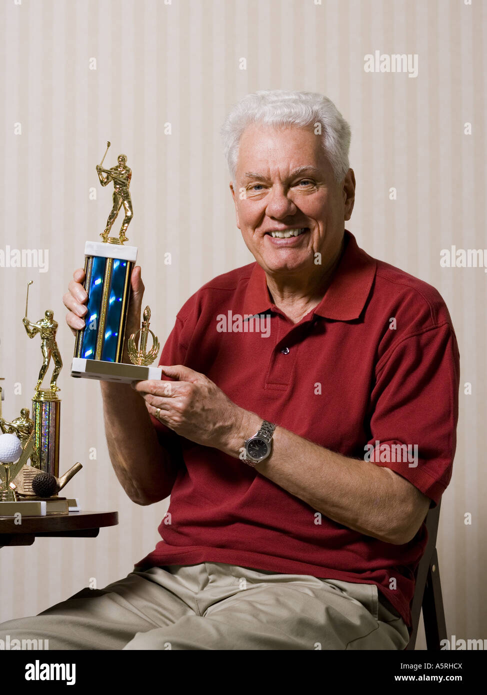 Portrait of a senior man holding a trophy Stock Photo - Alamy