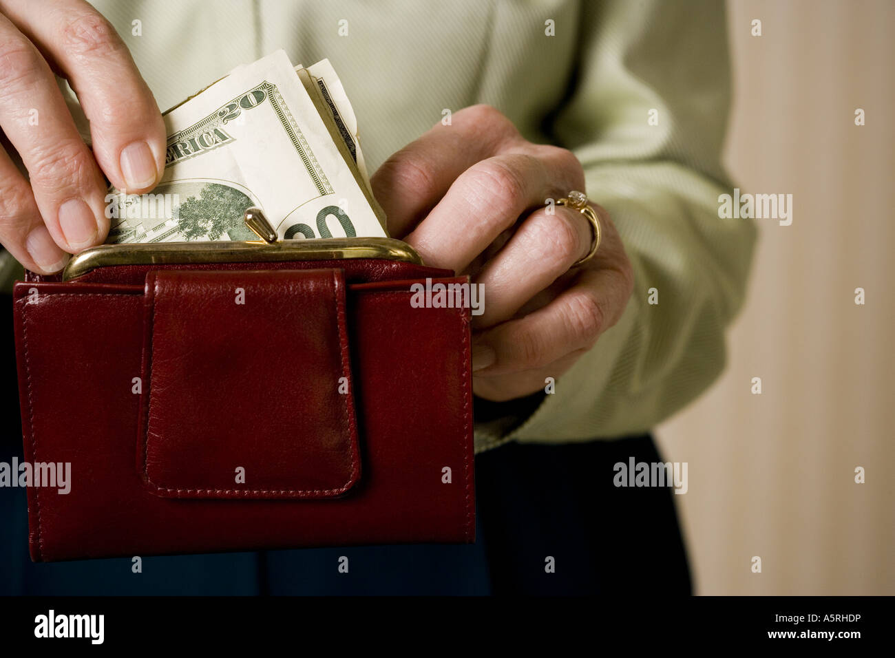 Mid section view of a woman keeping paper currency in a purse Stock ...