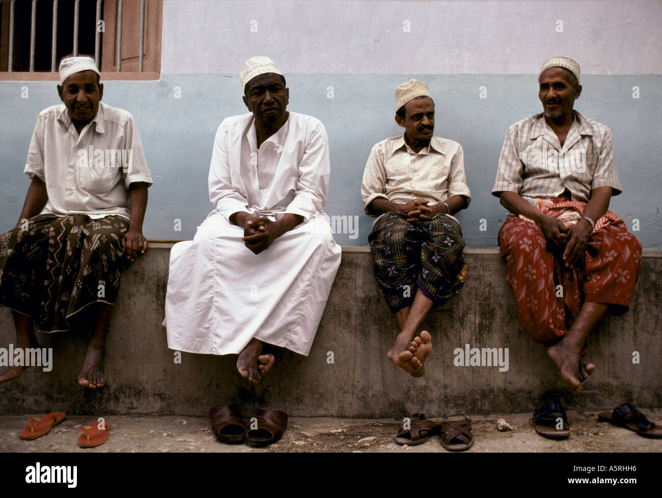 MUSLIM MEN SITTING OUTSIDE MOSQUE AFTER FRIDAY PRAYER ON ZANZIBAR ...