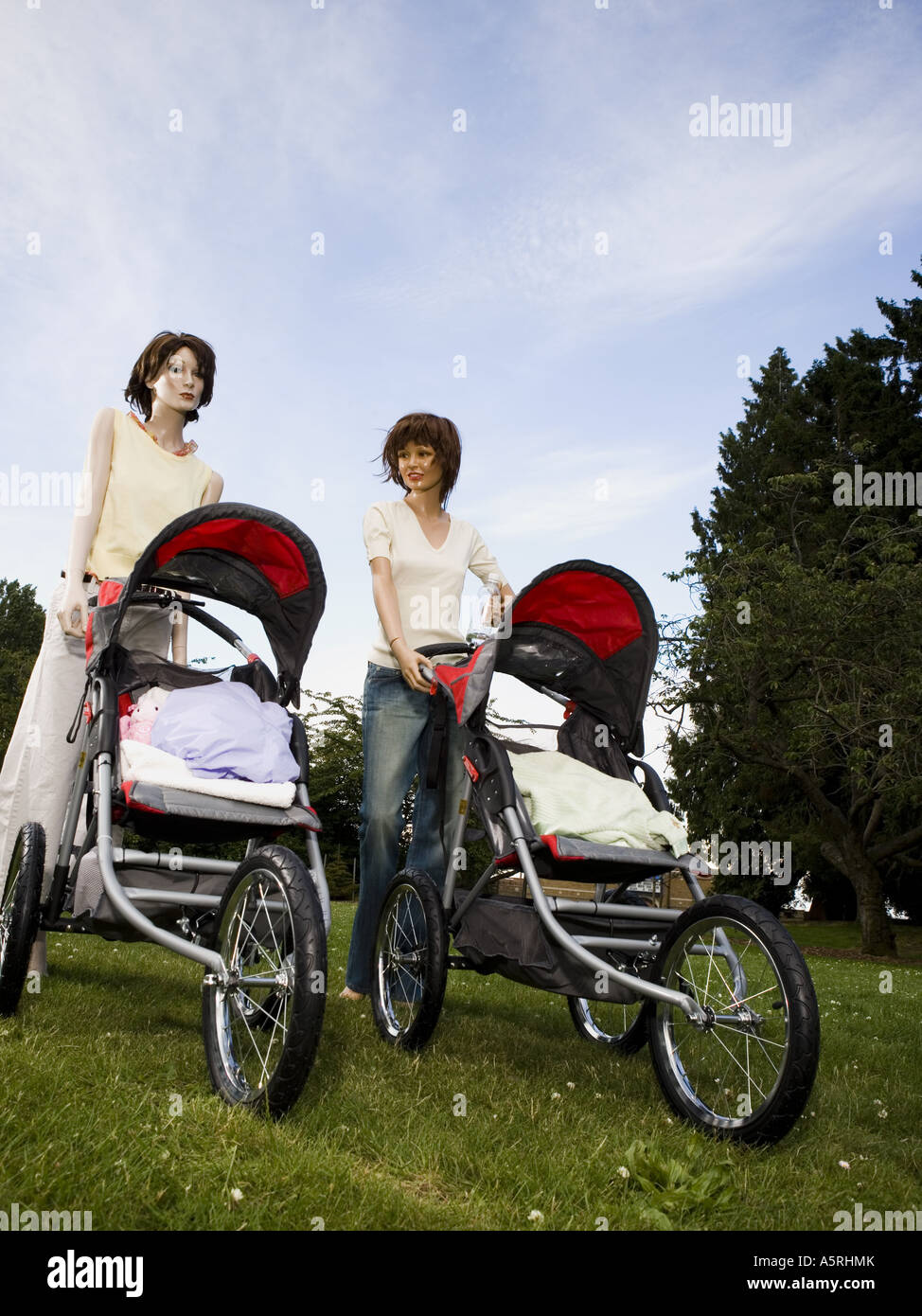 Low angle view of two mannequins portraying mothers pushing prams Stock ...