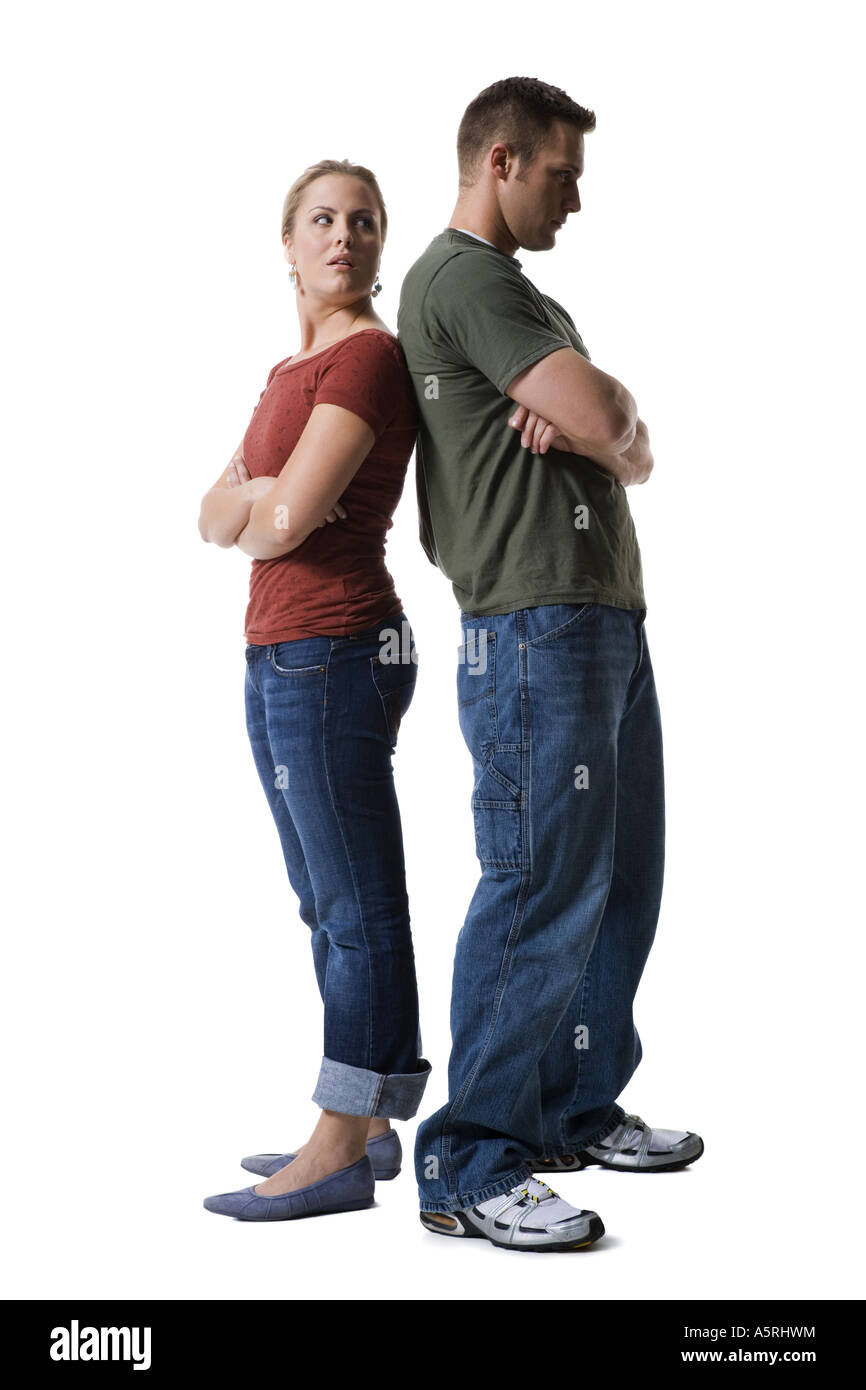 Profile of a young couple standing back to back Stock Photo - Alamy