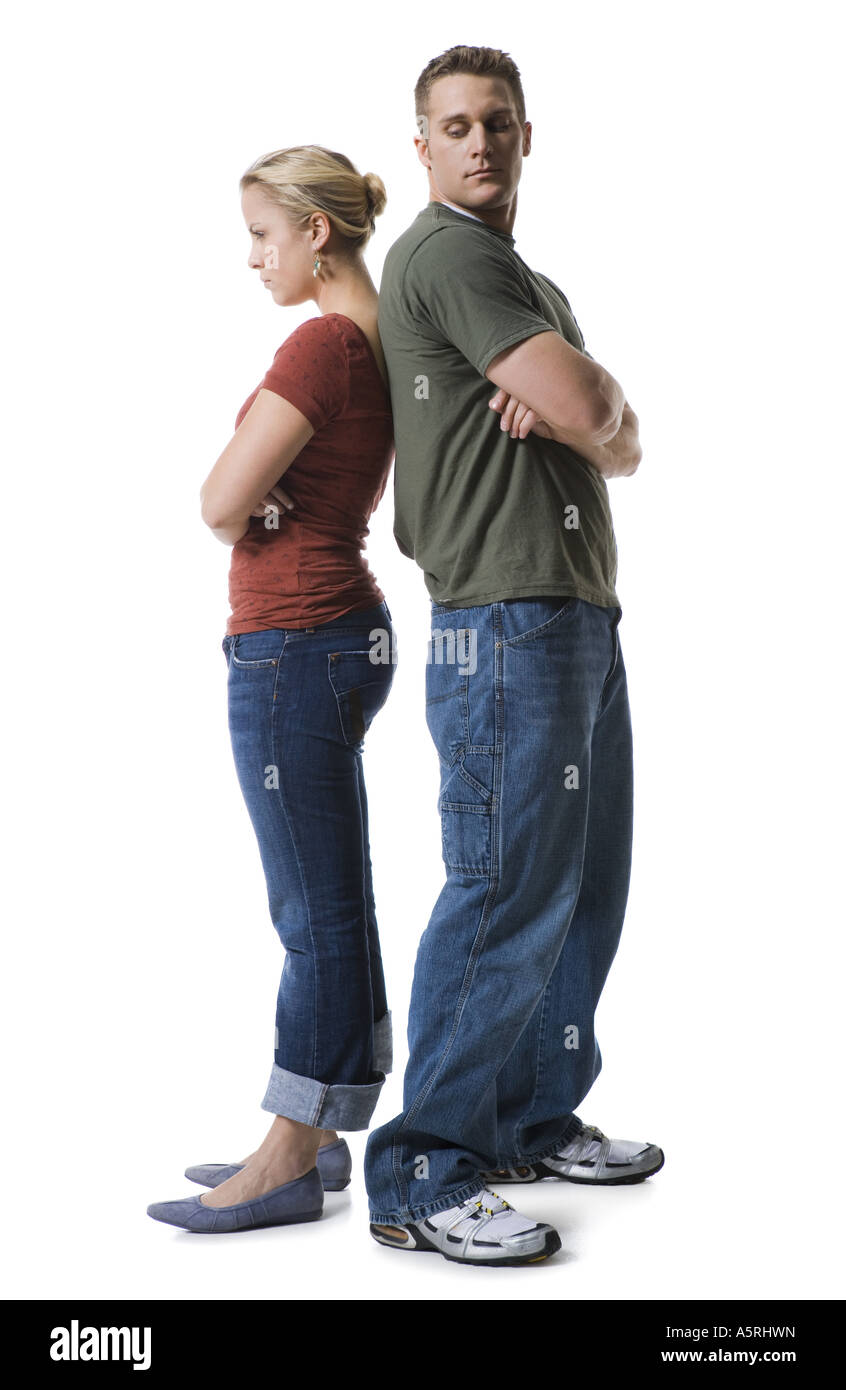Profile of a young couple standing back to back Stock Photo - Alamy