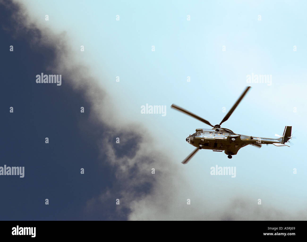 Military helicopter flying into smoke Stock Photo - Alamy