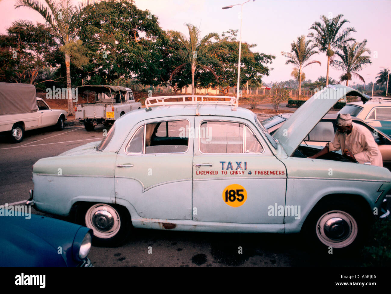 ZANZIBAR ISLAND MAN WORKING ON TAXI'S ENGINE, EAST AFRICA Stock Photo ...