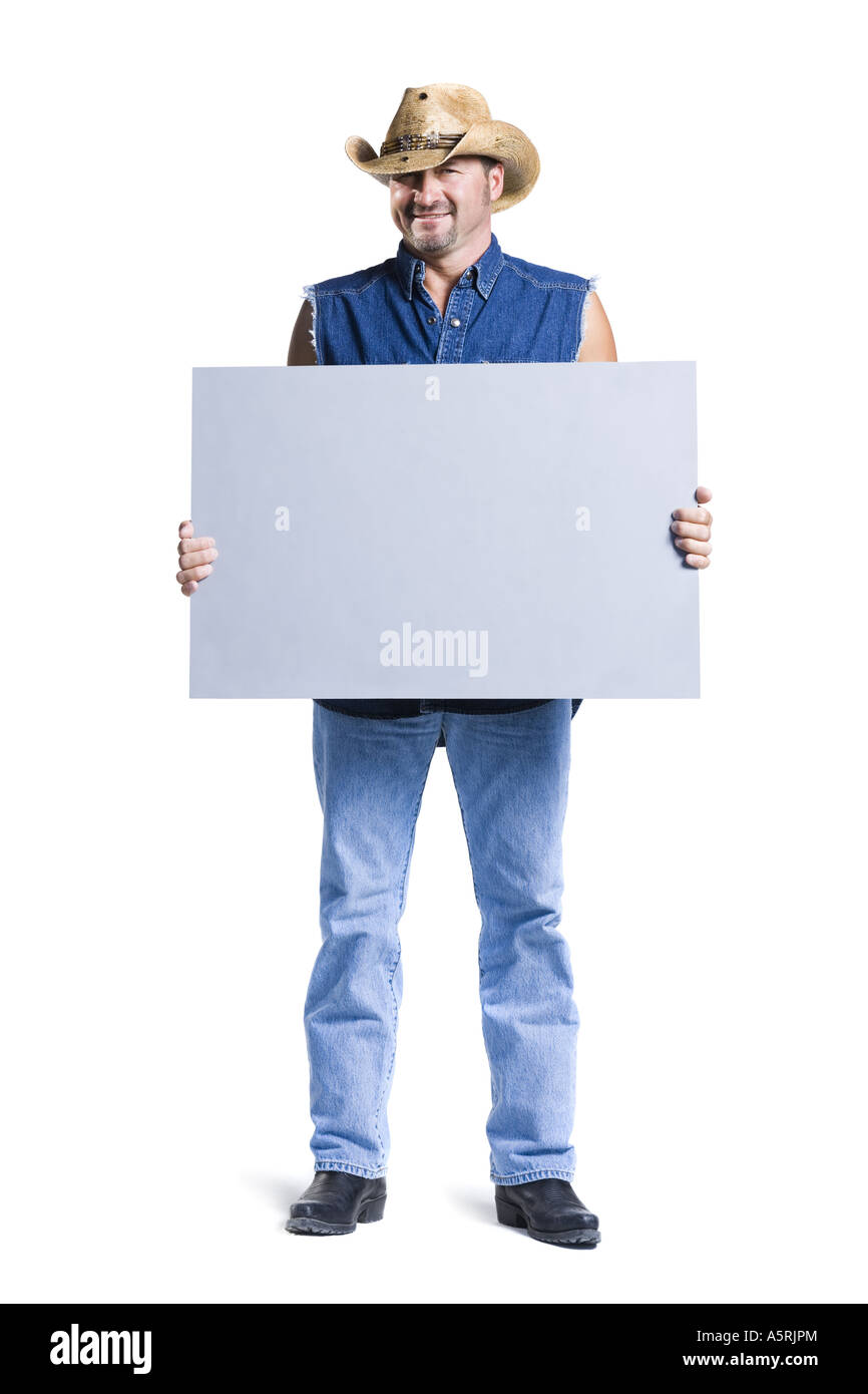 Cowboy holding blank sign Stock Photo - Alamy