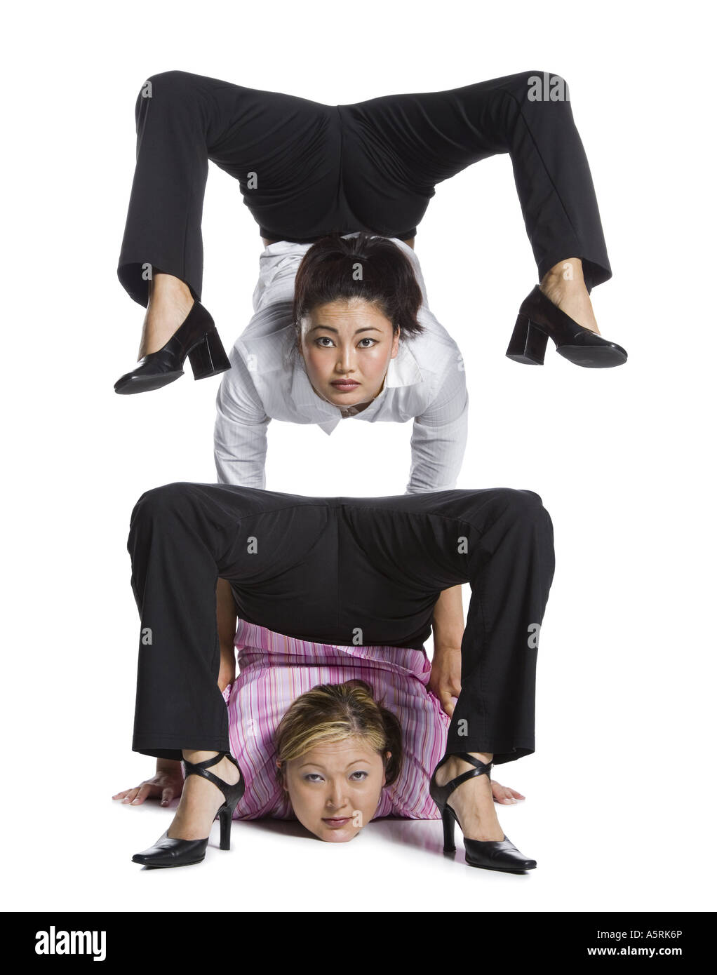 Two female contortionist businesswomen hi-res stock photography and ...