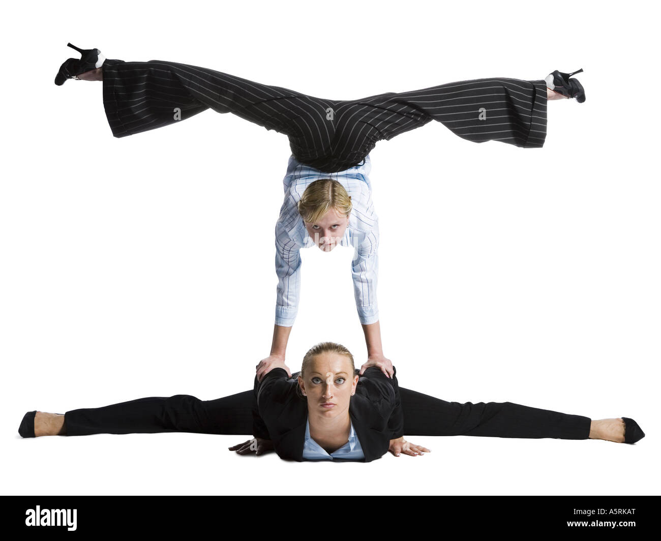 Two female contortionist businesswomen Stock Photo - Alamy