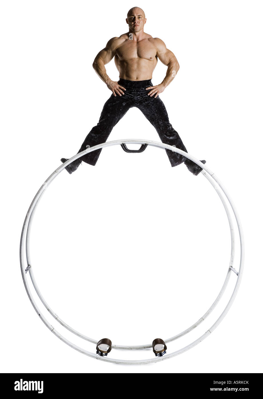 Male bodybuilder posing on top of German wheel Stock Photo - Alamy