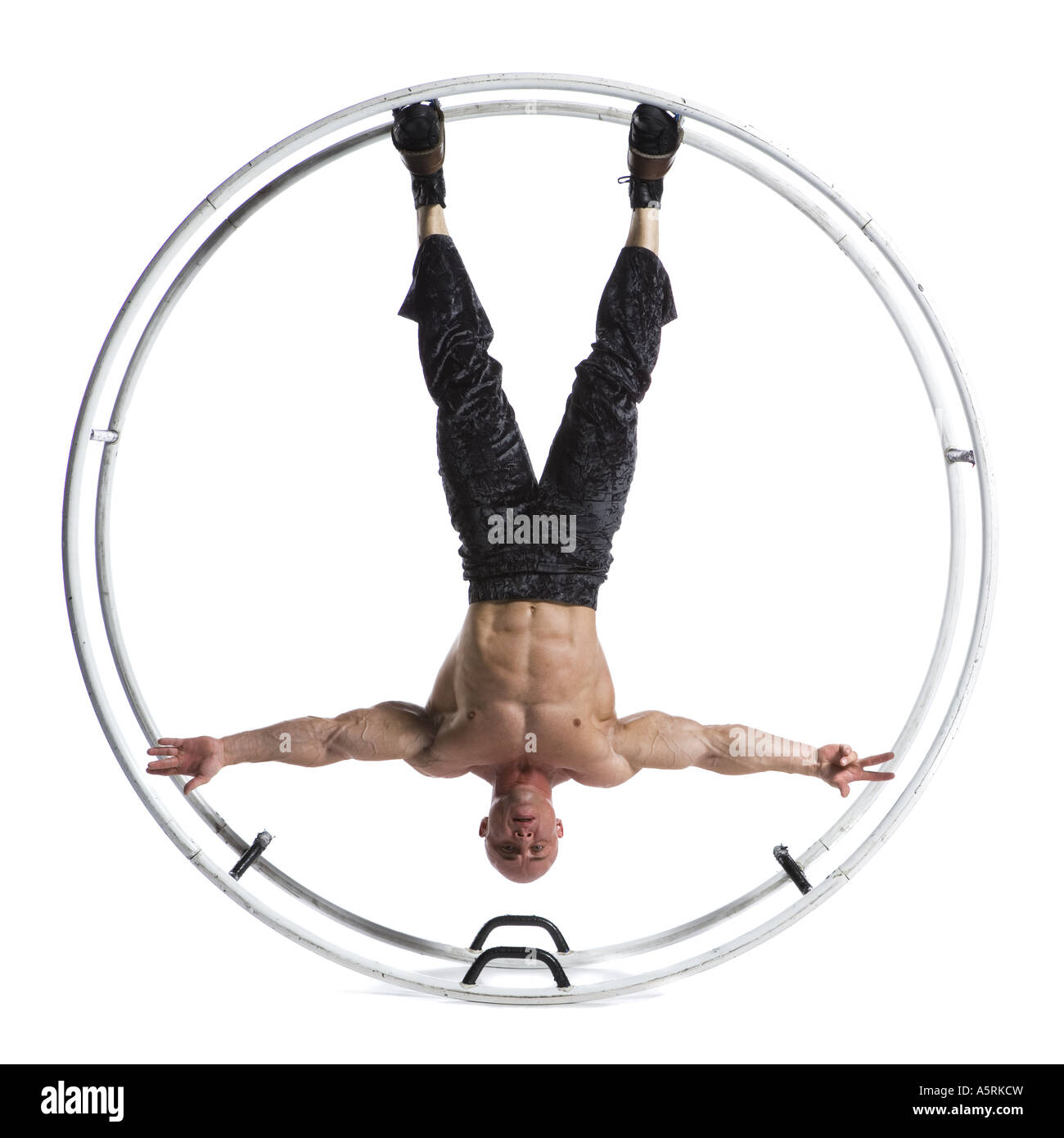 Male bodybuilder posing in German wheel Stock Photo - Alamy