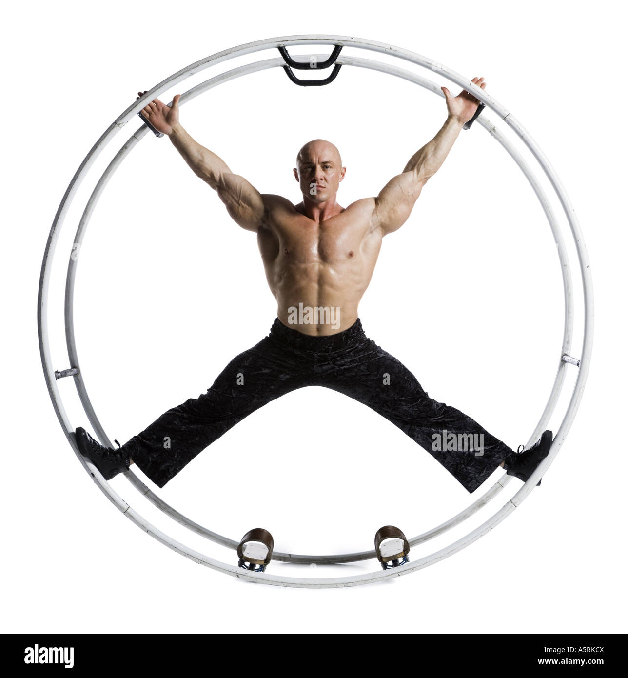 Male bodybuilder posing in German wheel Stock Photo - Alamy