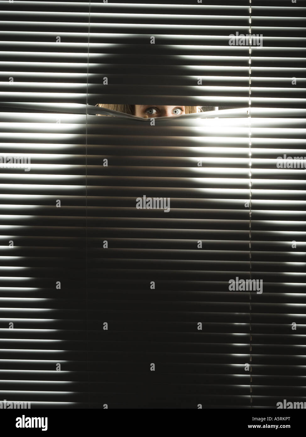 Peeping through blinds hi-res stock photography and images - Alamy