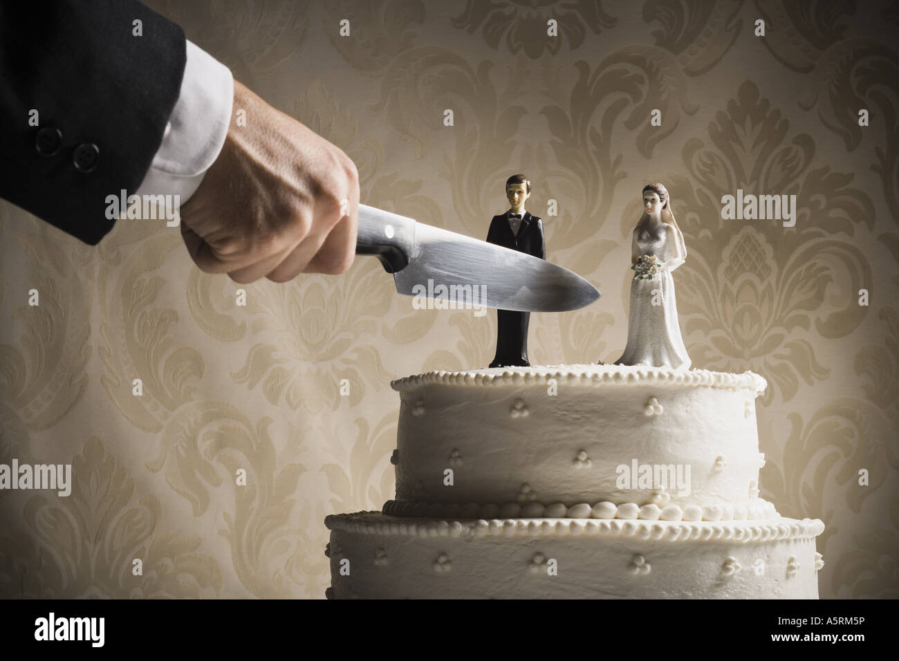 Wedding cake visual metaphor with figurine cake toppers Stock Photo - Alamy