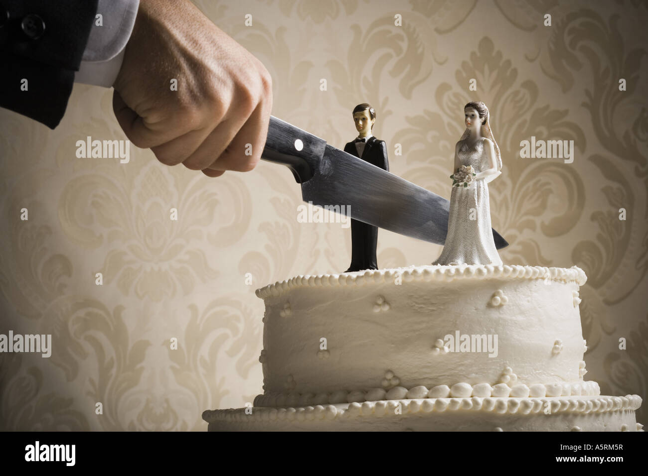 Wedding cake visual metaphor with figurine cake toppers Stock Photo - Alamy