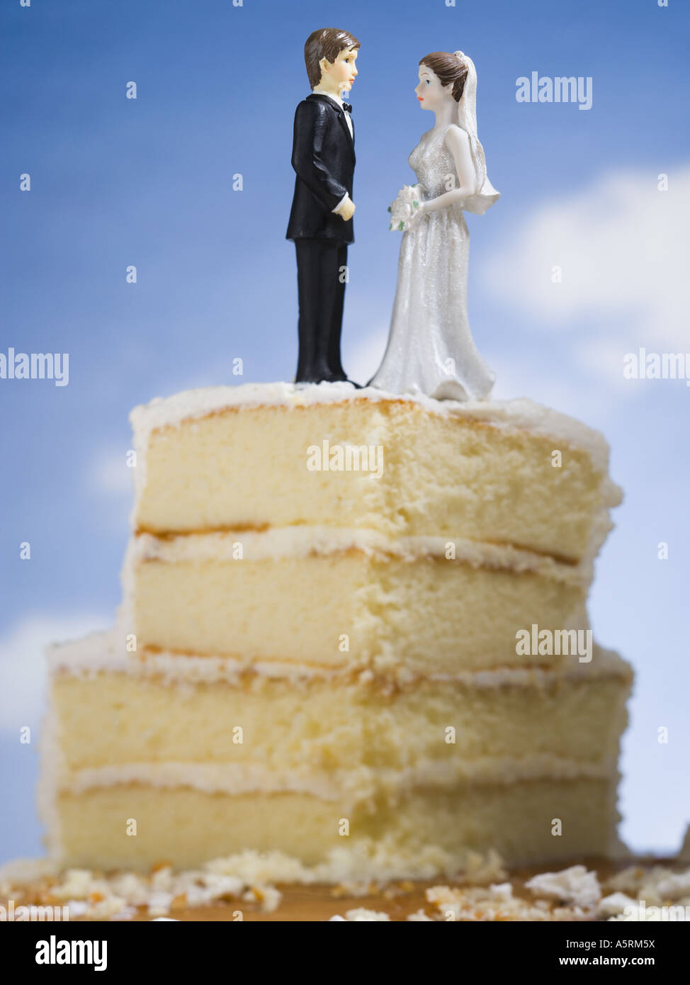 Wedding cake visual metaphor with figurine cake toppers Stock Photo - Alamy