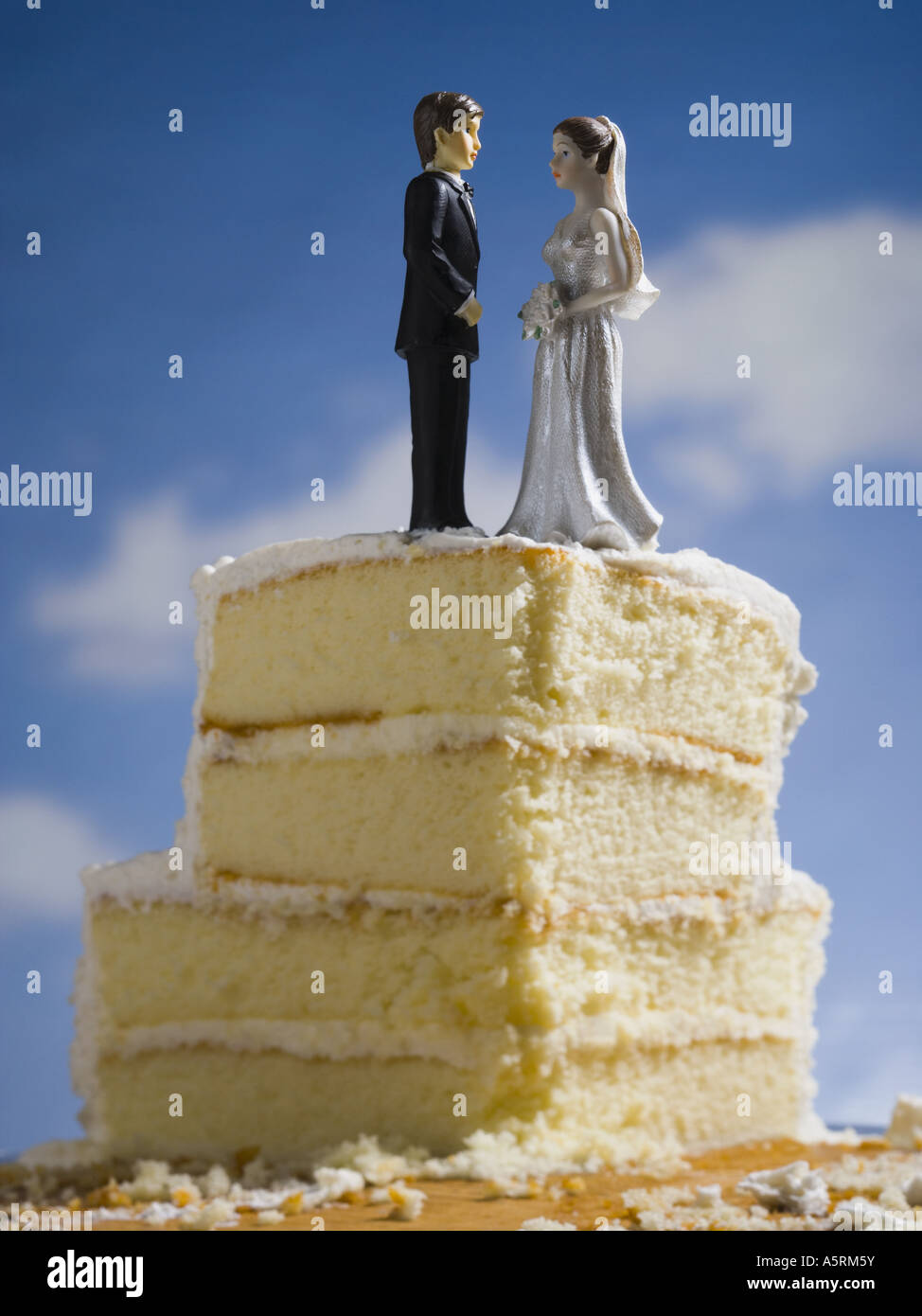 Wedding cake visual metaphor with figurine cake toppers Stock Photo - Alamy