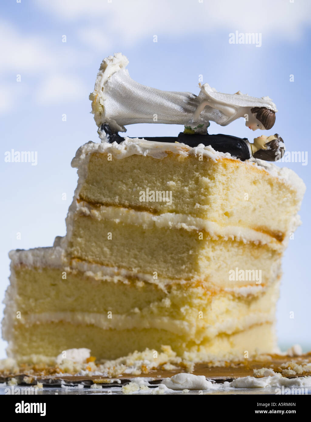 Wedding cake visual metaphor with figurine cake toppers Stock Photo - Alamy