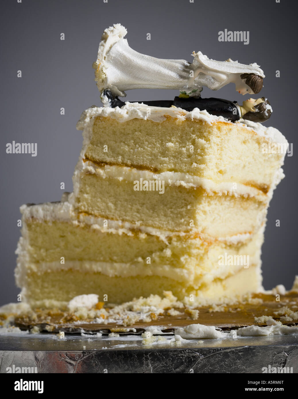 Wedding cake visual metaphor with figurine cake toppers Stock Photo - Alamy