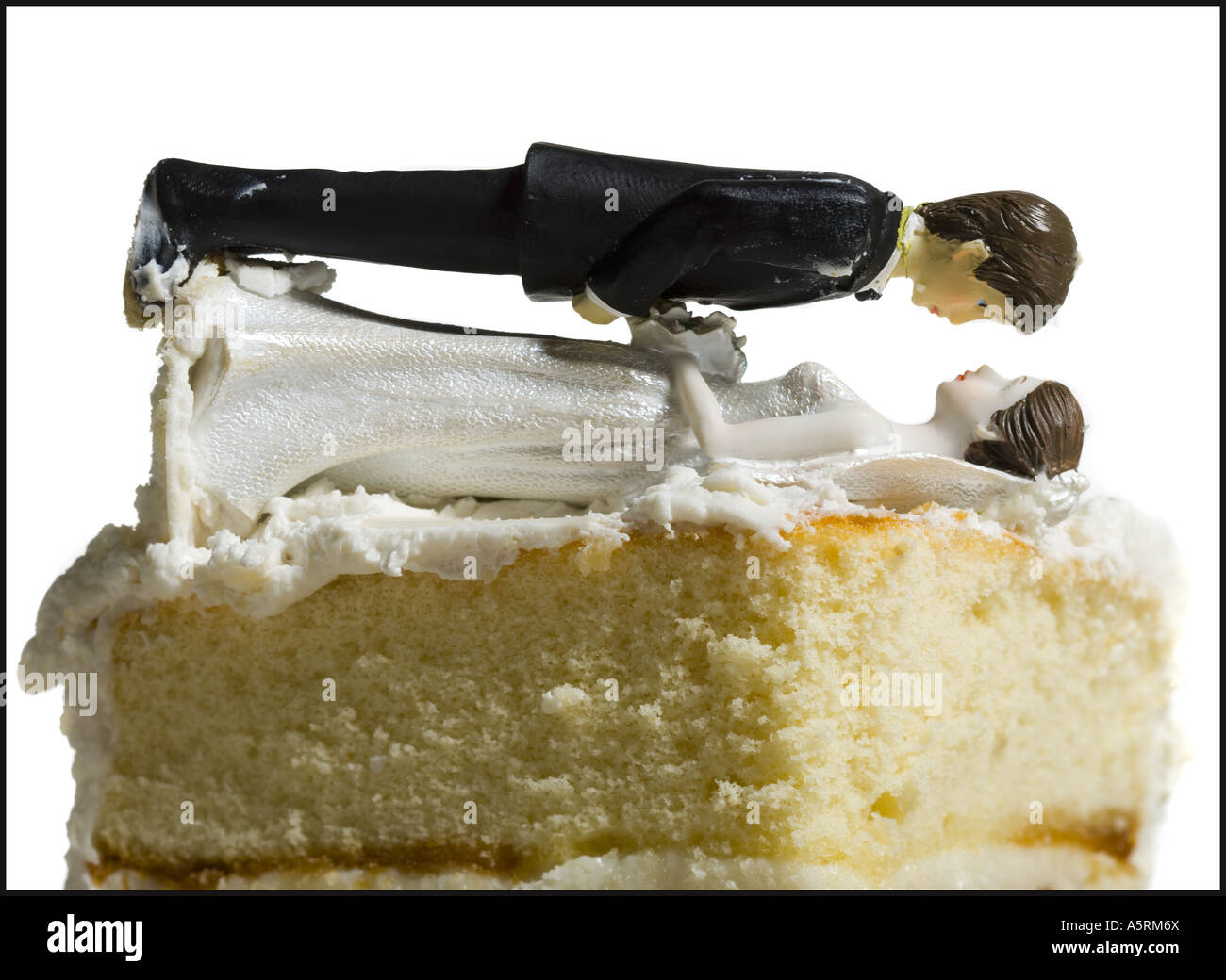 Wedding cake visual metaphor with figurine cake toppers Stock Photo - Alamy
