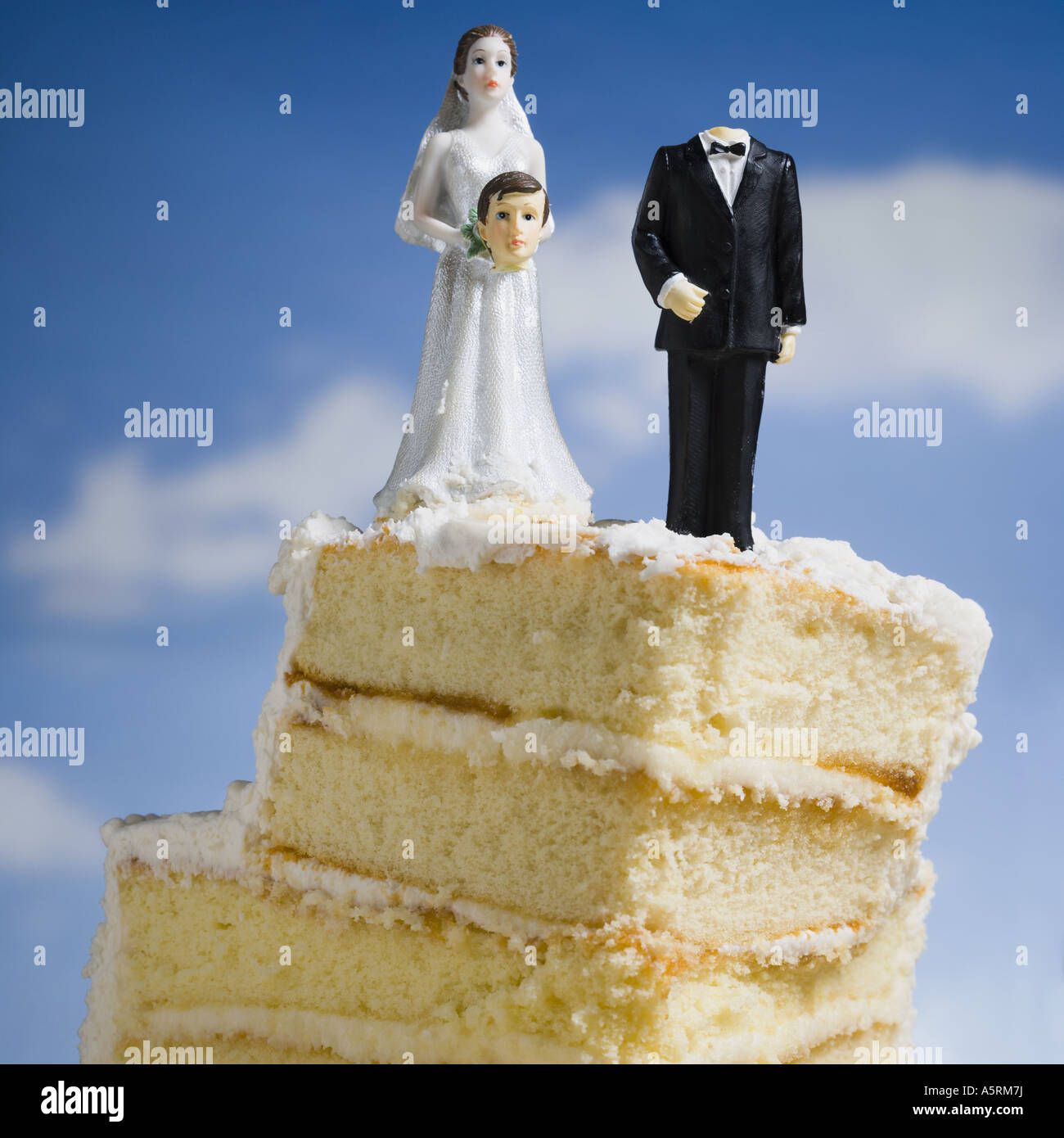 Wedding cake visual metaphor with figurine cake toppers Stock Photo - Alamy
