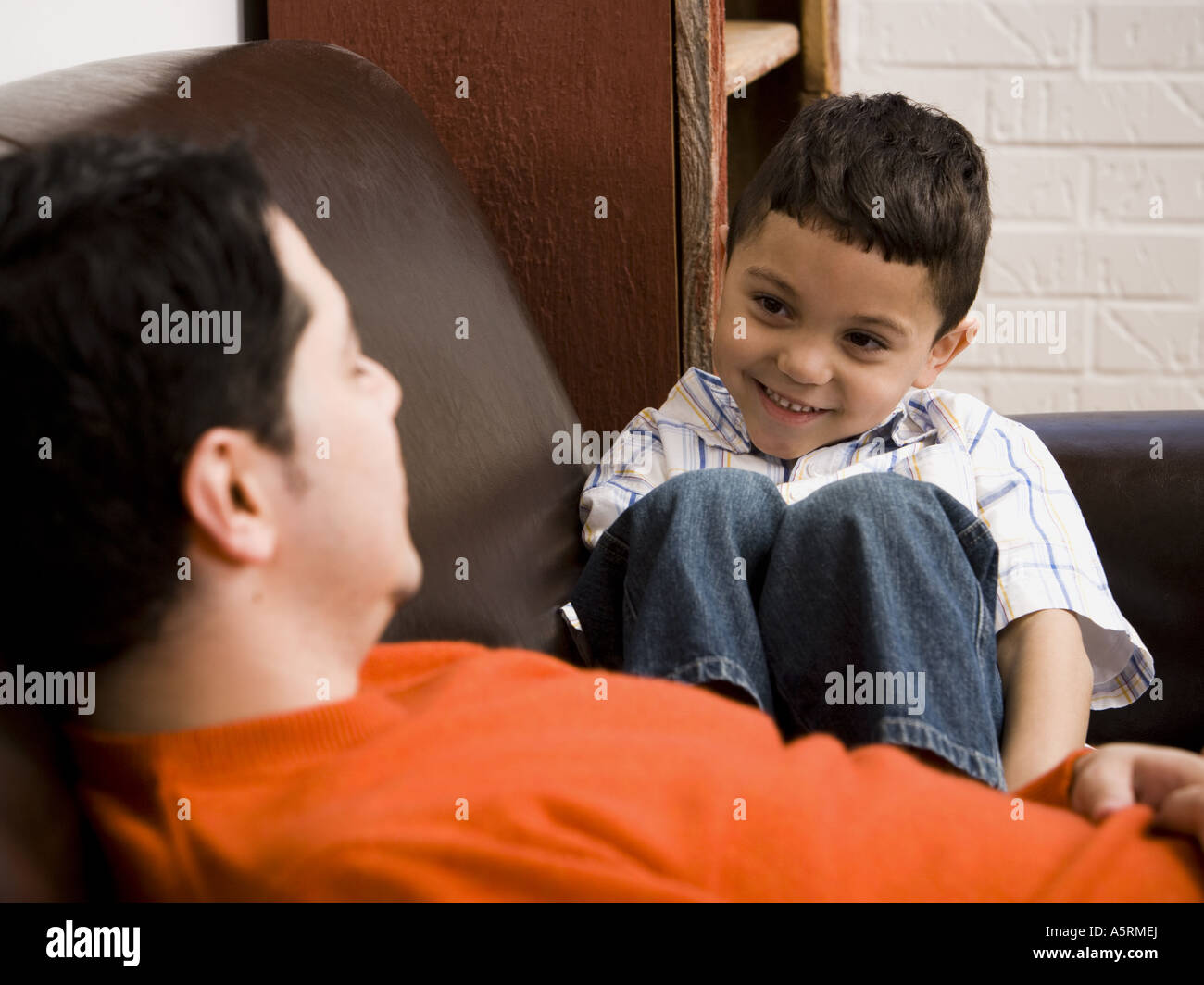 Father and young son talking Stock Photo - Alamy