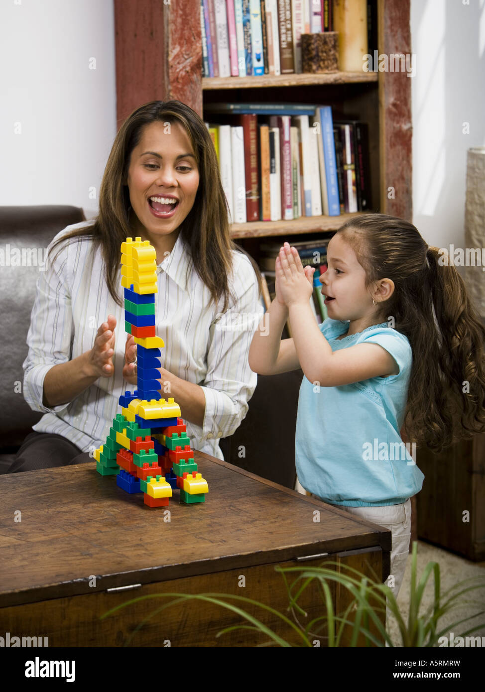 Mother and young daughter playing with building blocks Stock Photo - Alamy